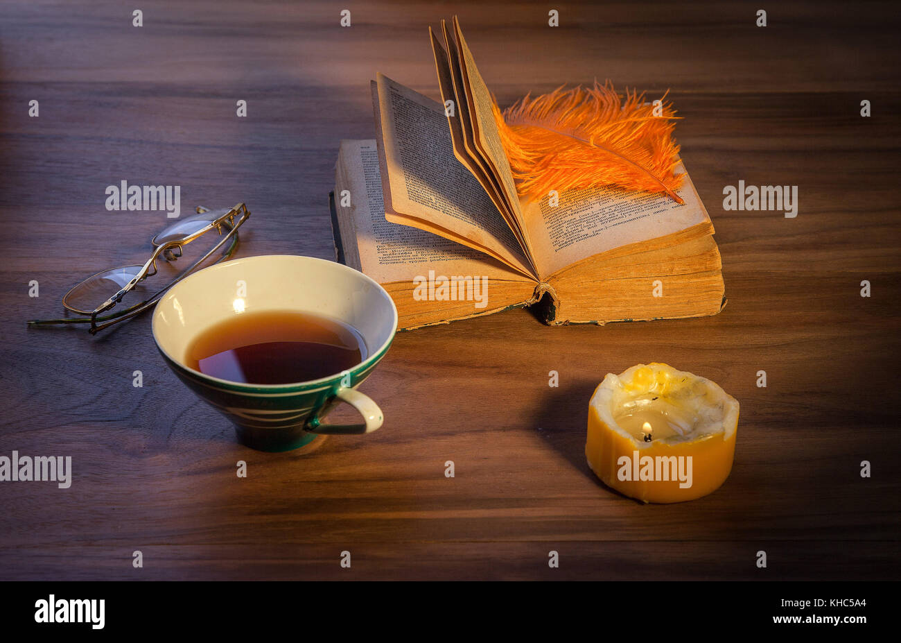Reading a book with a drink Stock Photo - Alamy