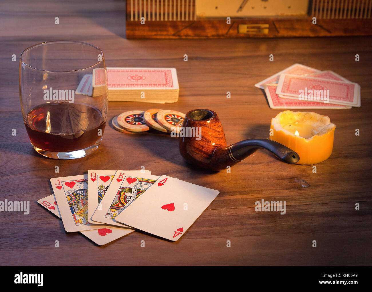 Playing cards with drinks and candle Stock Photo - Alamy