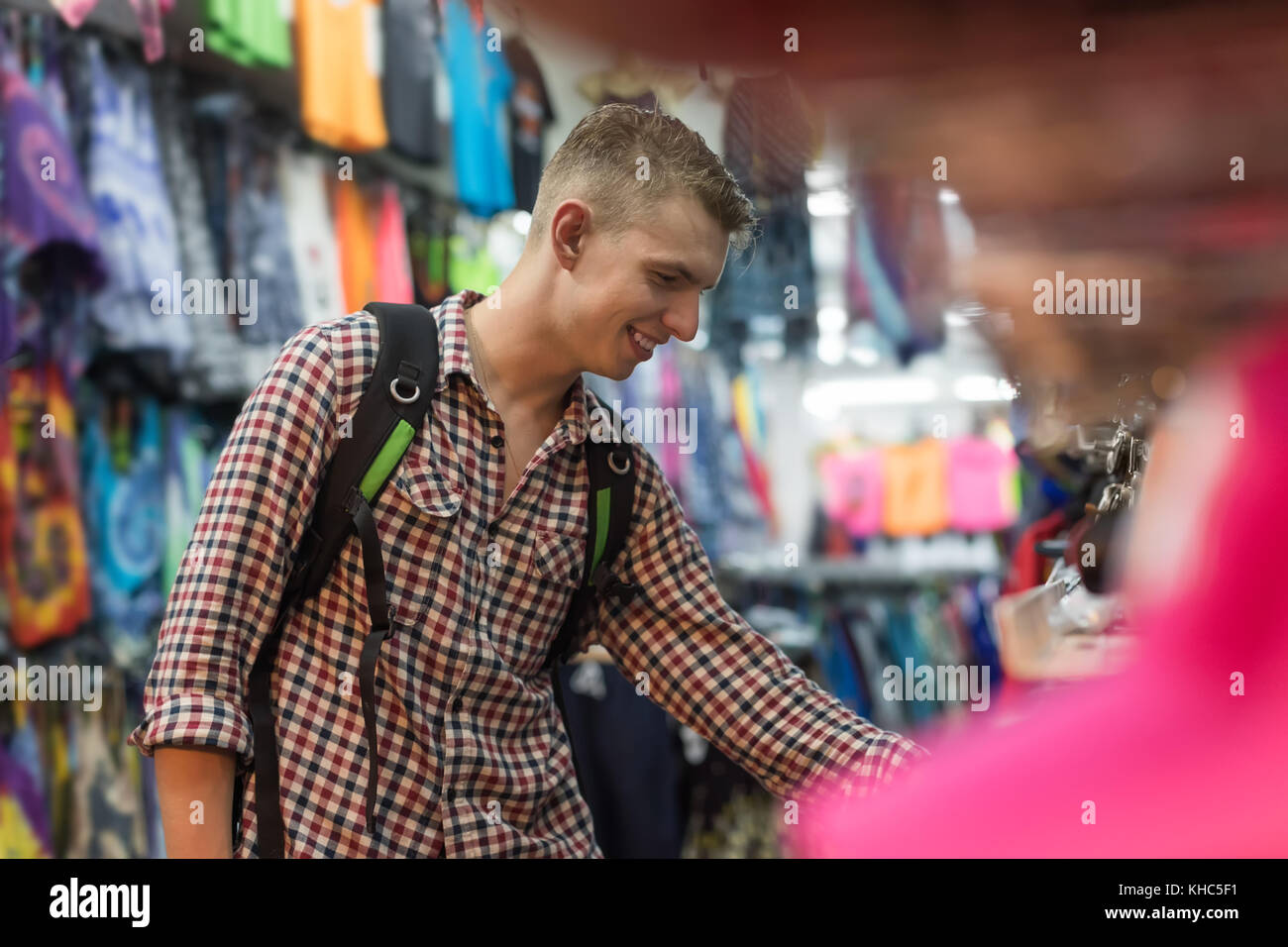 Young Man On Shopping Choosing Clothes, Guy Buyer Happy Smiling In ...