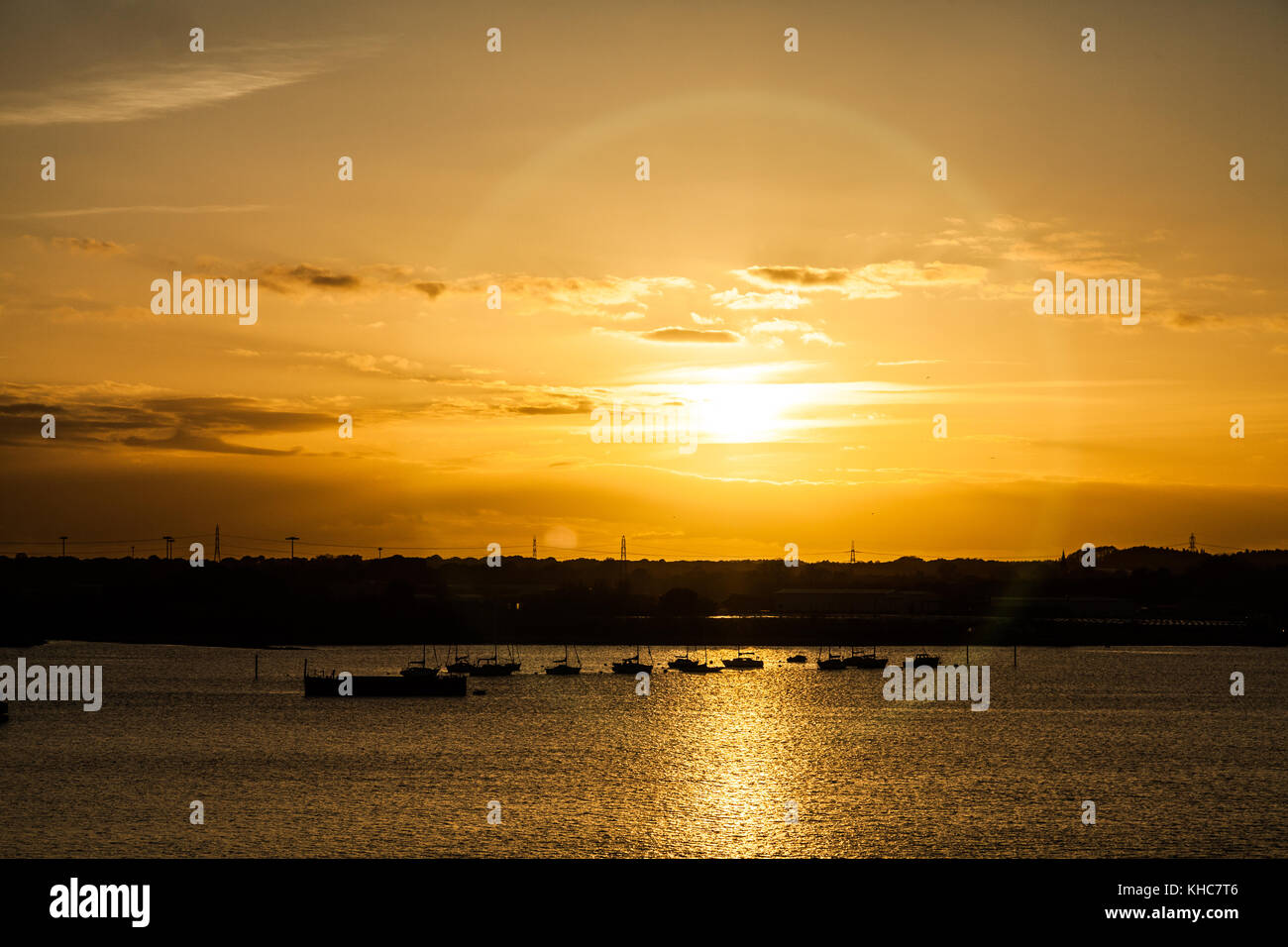 Sunset over harbour Stock Photo - Alamy
