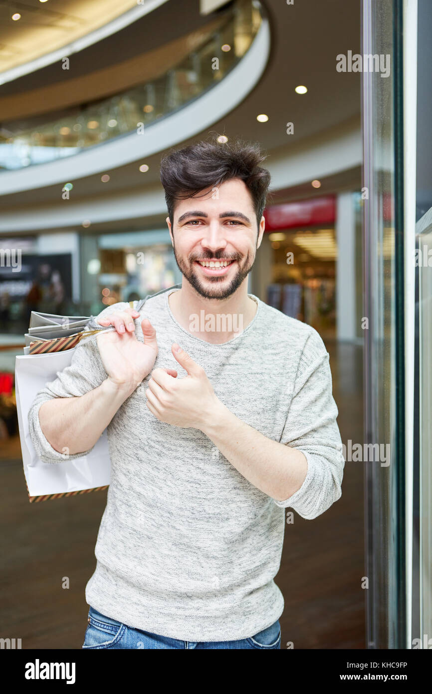 Young man as a consumer and customer in retail while shopping Stock ...