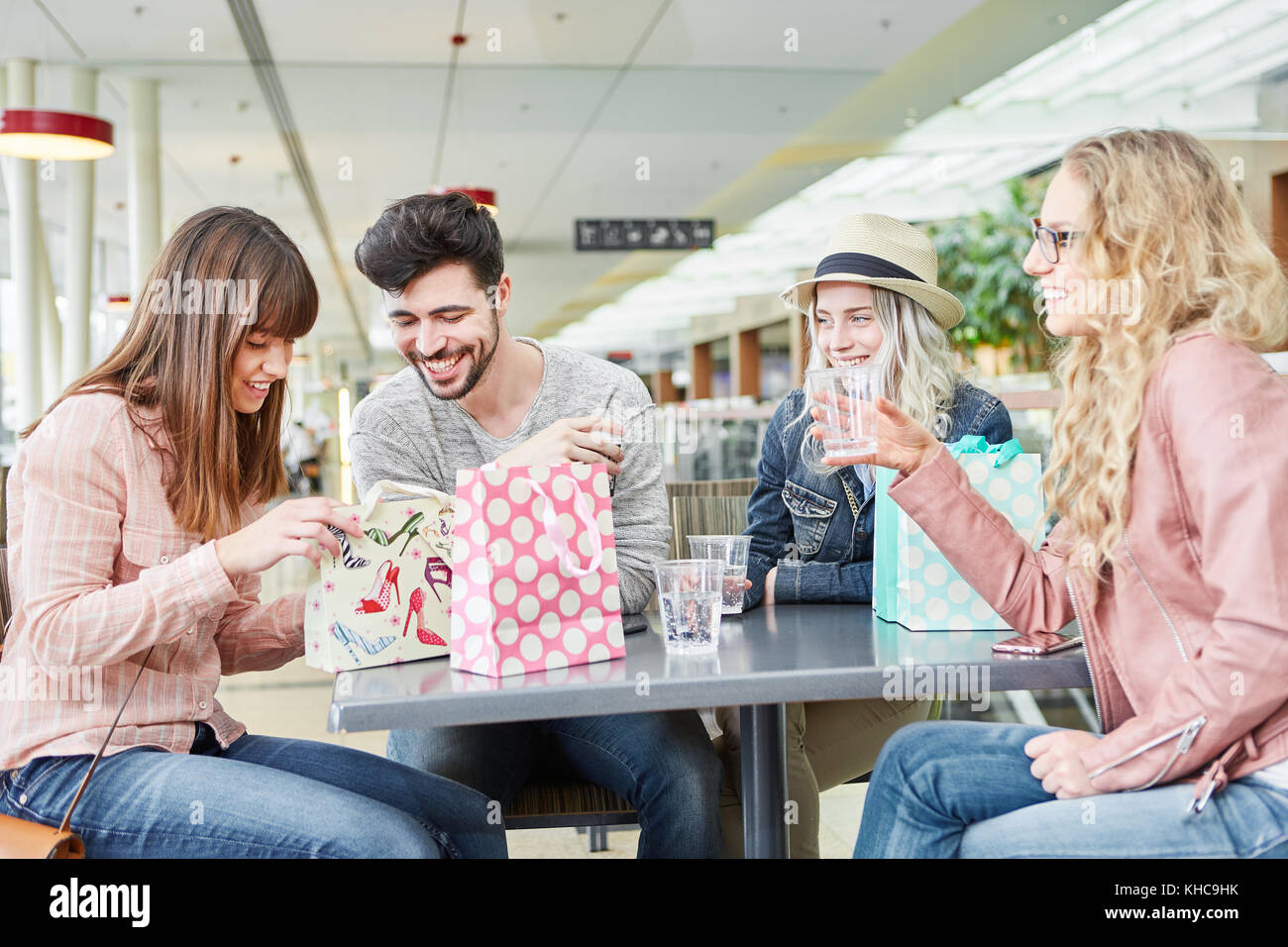 Group of teenagers as friends relaxes in the restaurant from shopping ...