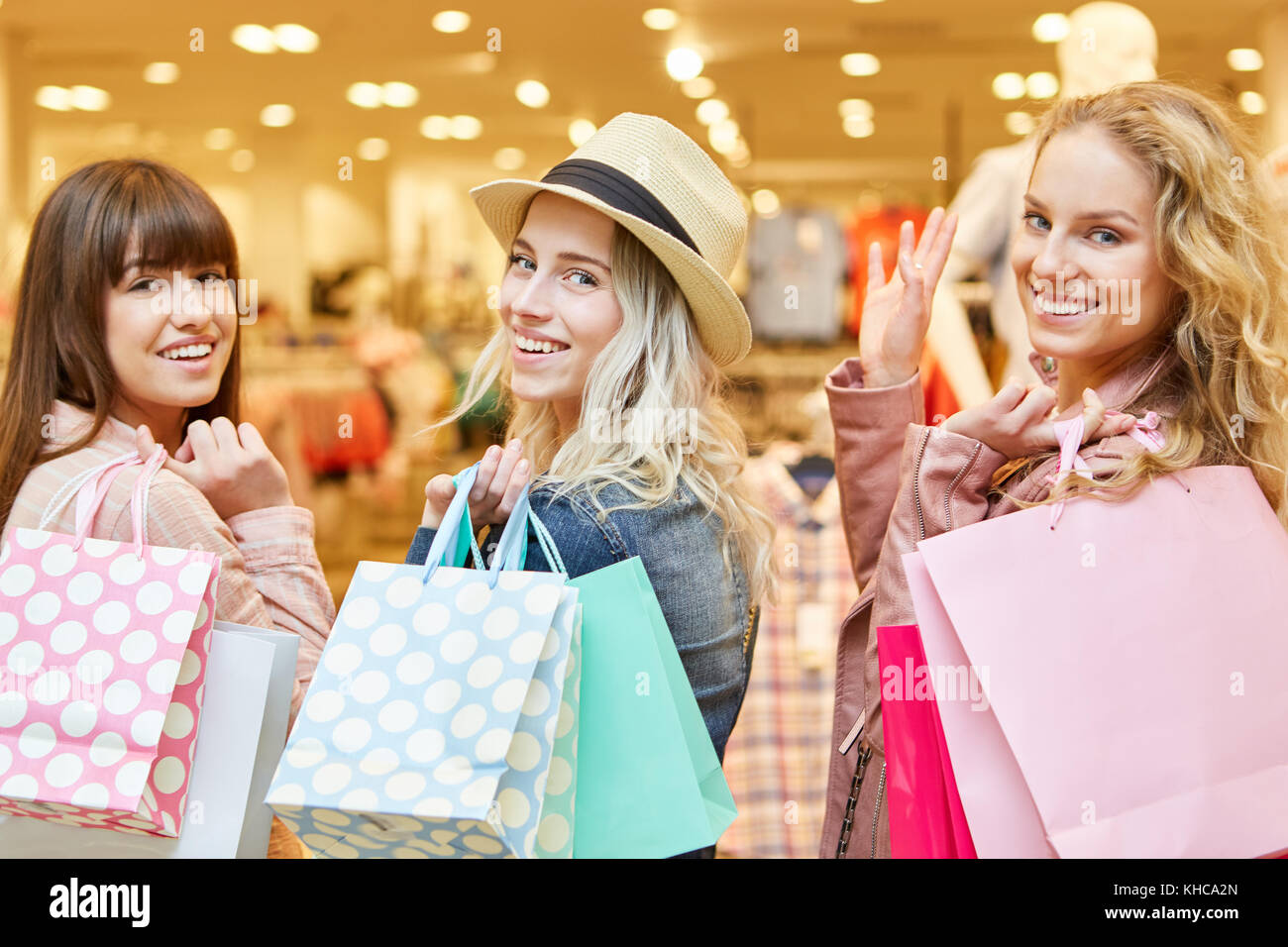 Female friends enjoy shopping together in the fashion shop Stock Photo ...