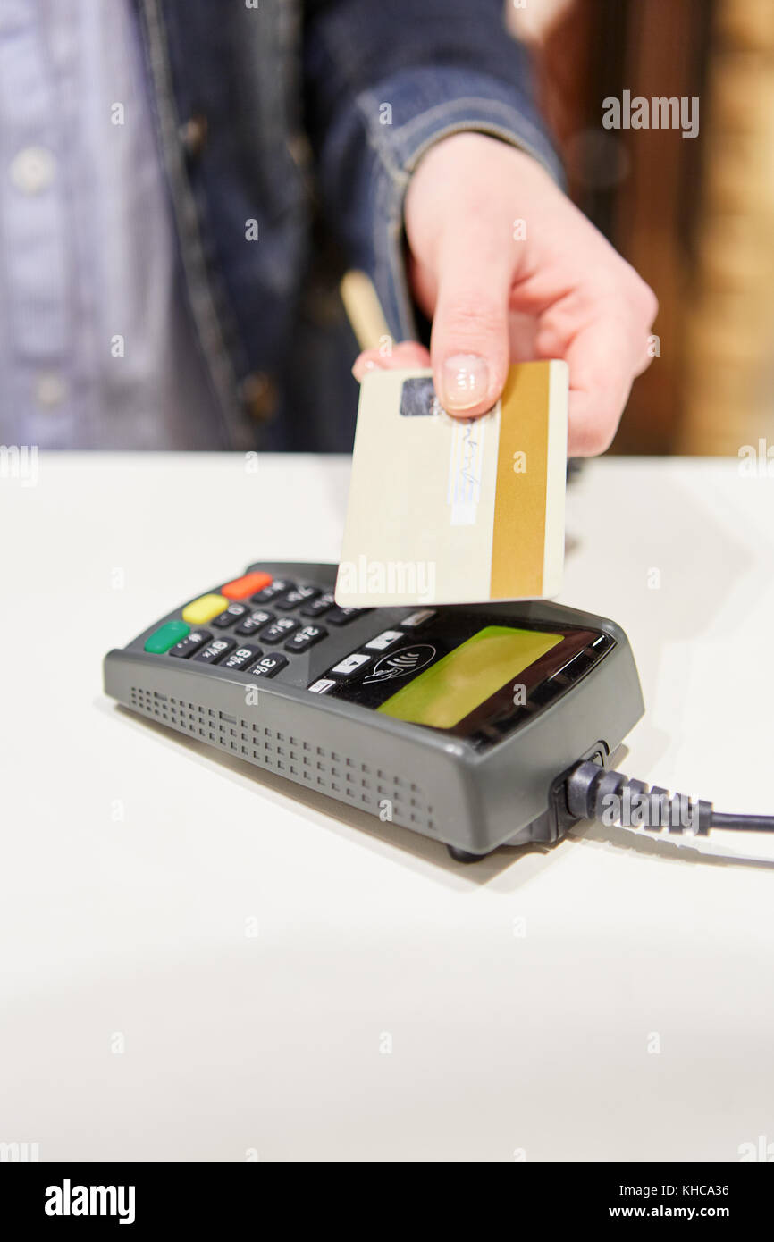 Customer pays cash-free with credit card and makes mobile payment at ...