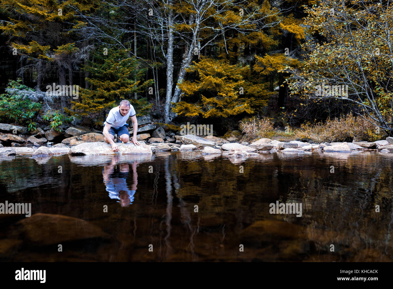 Man touching reflection in water hi-res stock photography and images ...