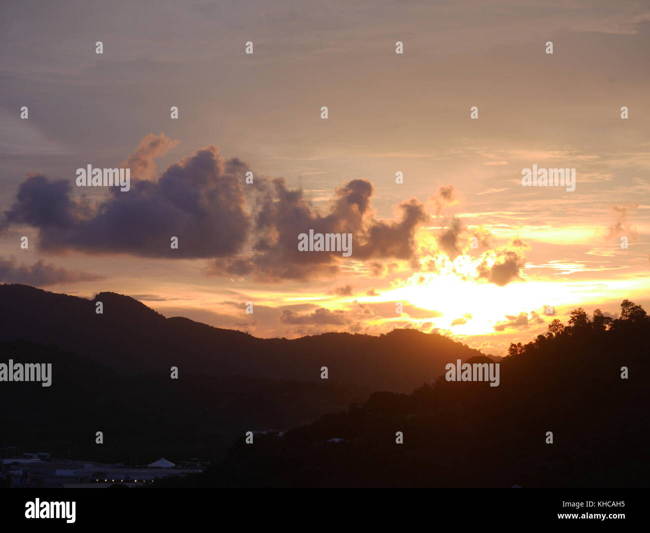Sunset behind mountain There is a beautiful evening sunlight cloudy sky ...