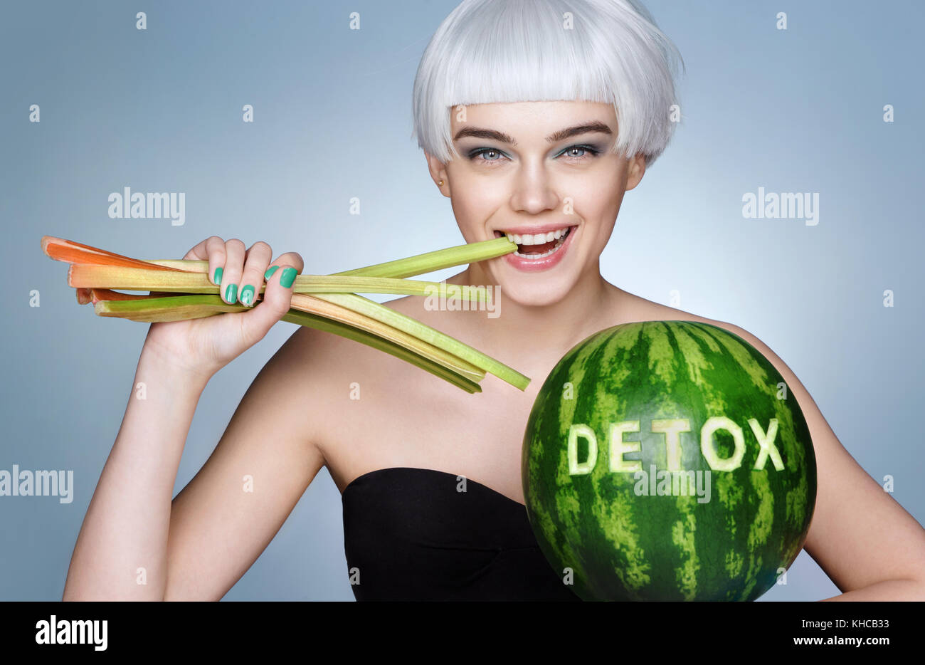 Funny young girl bites celery. Photo of smiling blonde girl with celery ...