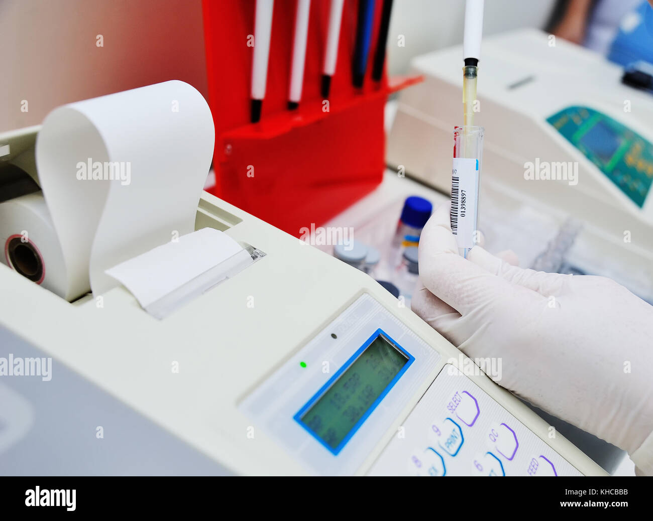 A laboratory scientist with a dispenser in his hands conducts ...