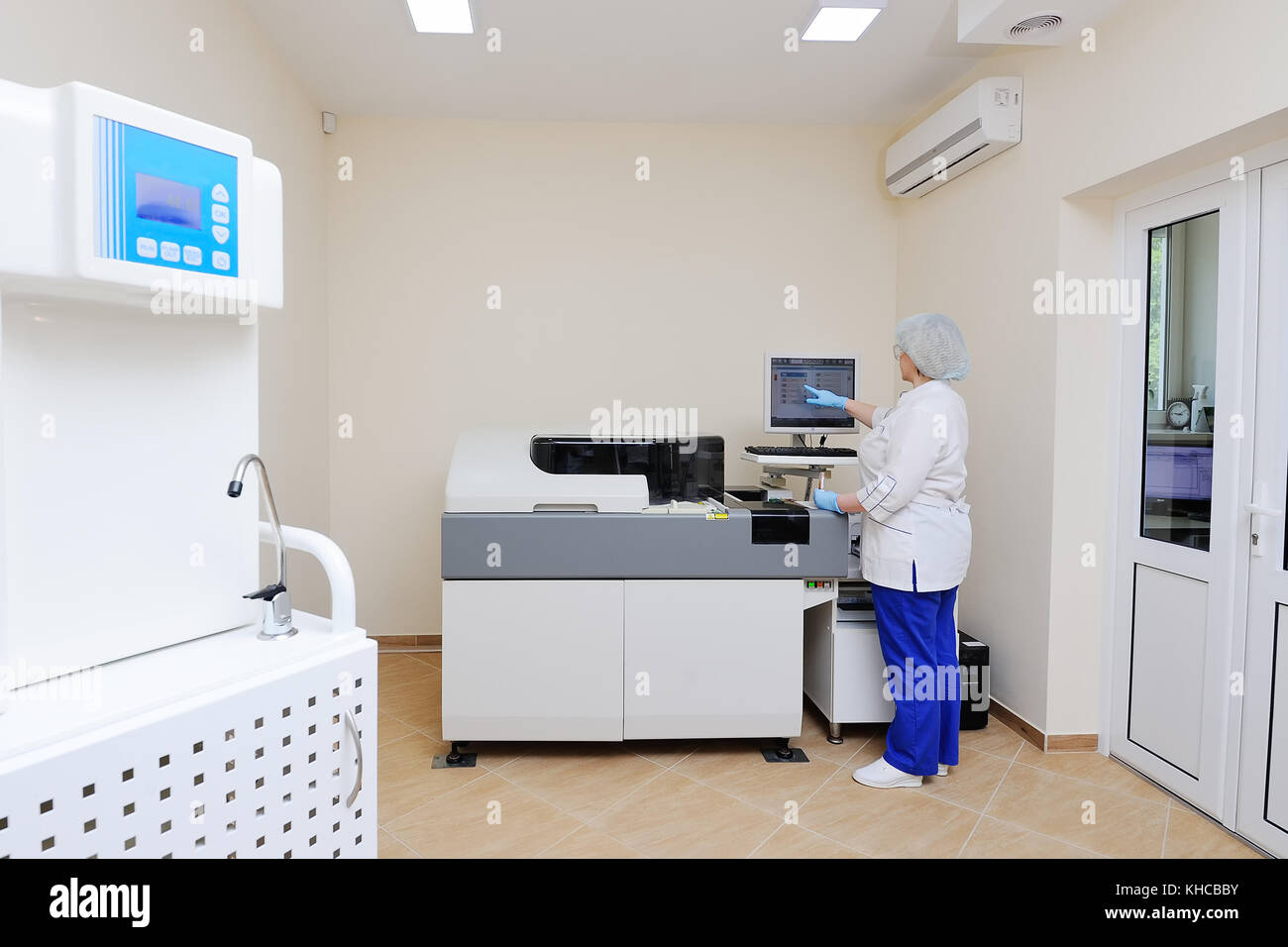 scientist near the analyzer in a medical microbiological laboratory ...