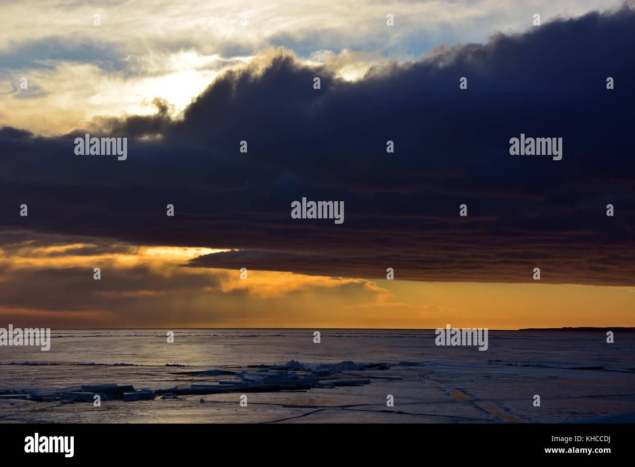 Sunset over frozen sea. Stormy clouds, evening Stock Photo - Alamy