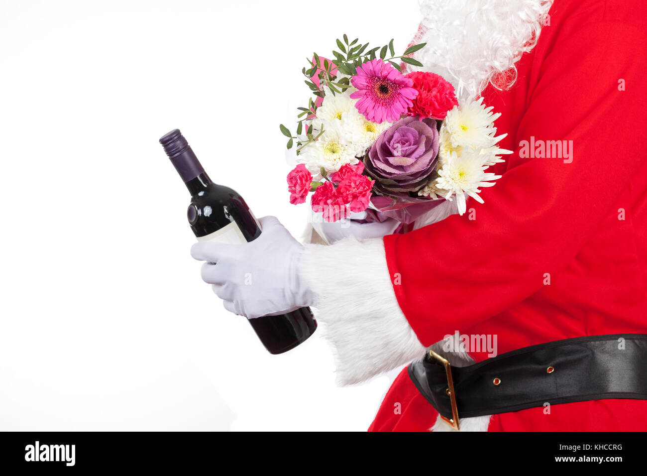 Father christmas offering a bunch of fresh flowers and a bottle of wine ...