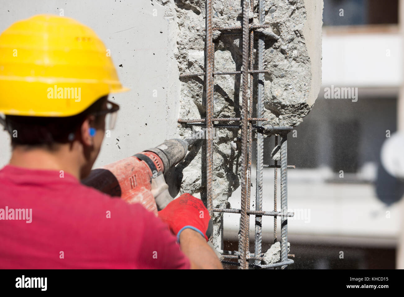 Construction worker using a drilling power tool Stock Photo - Alamy
