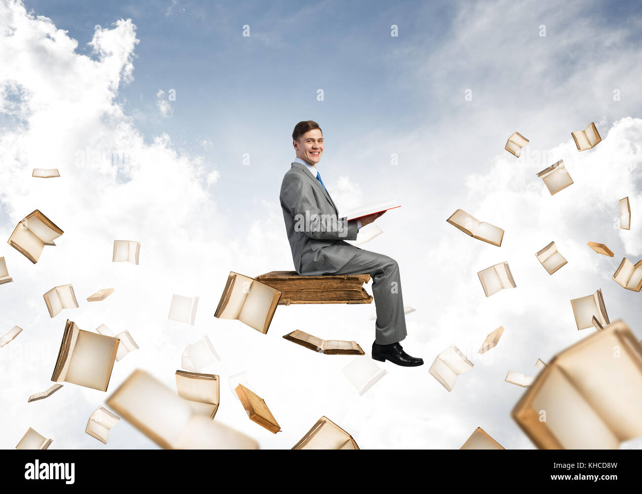 Man reading book and many of them flying in air Stock Photo - Alamy