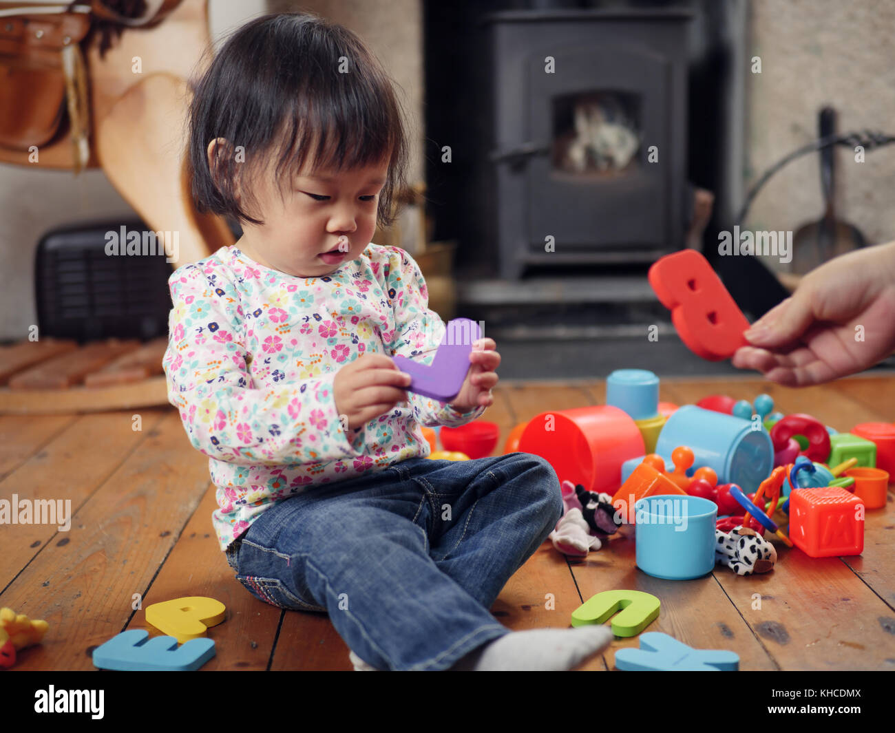 baby girl playing alphabet blocks at home Stock Photo - Alamy
