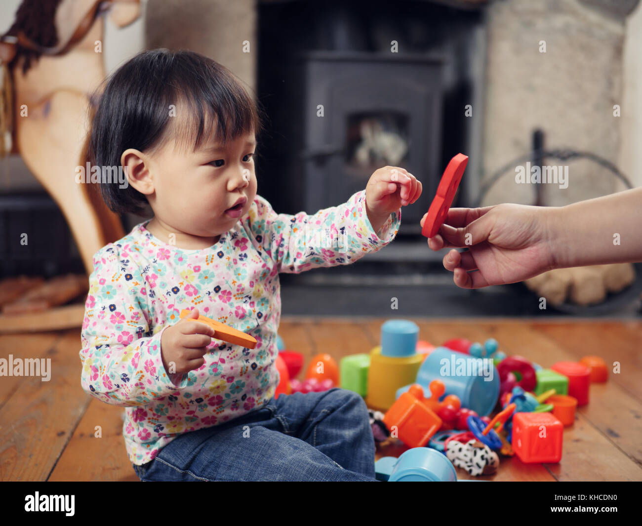 baby girl playing alphabet blocks at home Stock Photo - Alamy