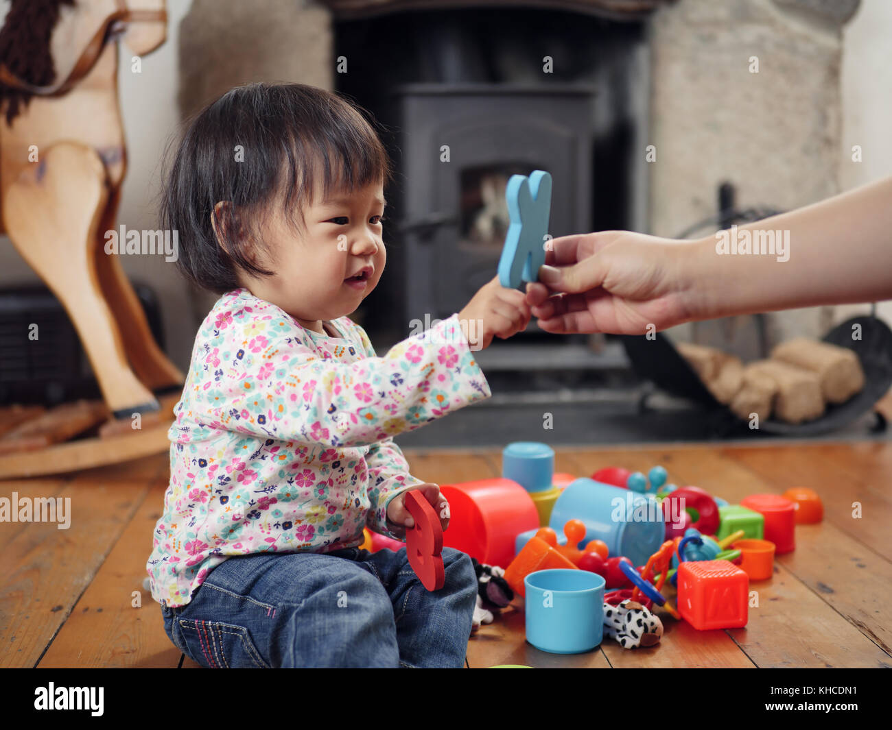 baby girl playing alphabet blocks at home Stock Photo - Alamy