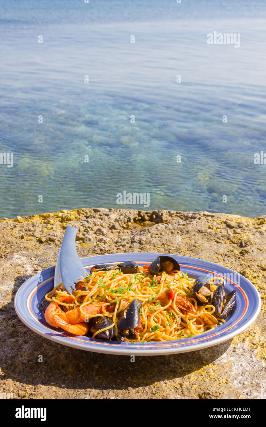 seafood with pasta by the sea in a greek island Stock Photo - Alamy