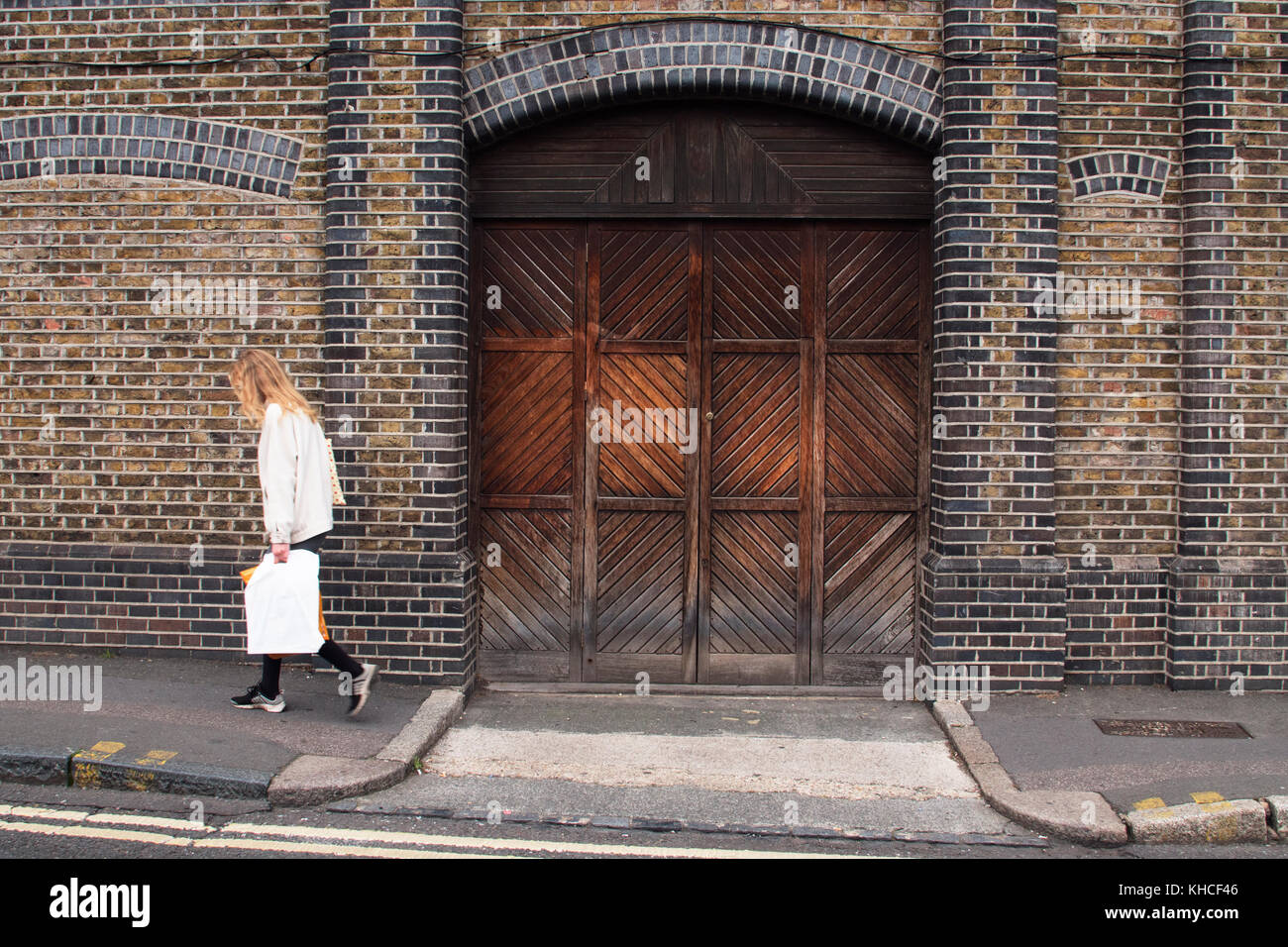 Old building on the canal near Broadway Market, Hackney, London. Woman ...