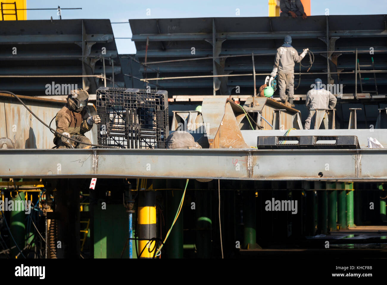 Workers in a dockyard assembling ship blocks. Camranh shipyard. Vietnam ...