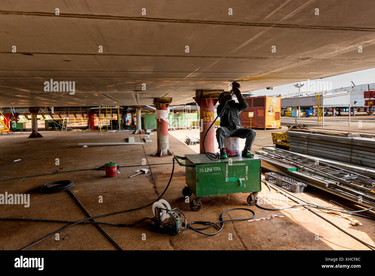 Workers in a dockyard assembling ship blocks. Camranh shipyard. Vietnam ...