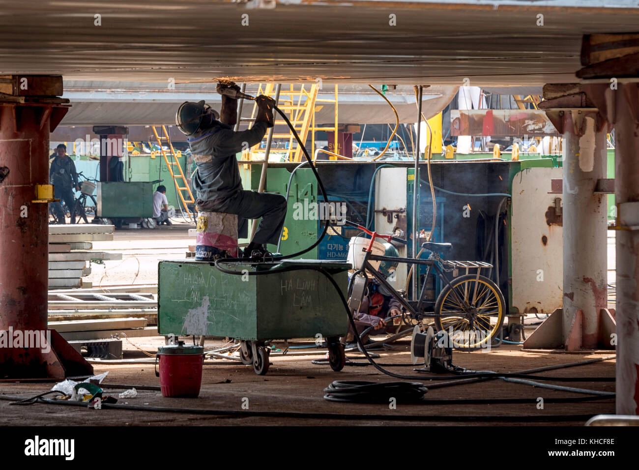 Workers in a dockyard assembling ship blocks. Camranh shipyard. Vietnam ...