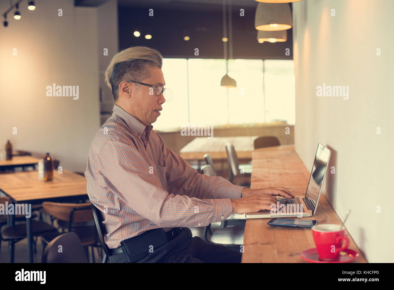 asian senior man using laptop Stock Photo - Alamy