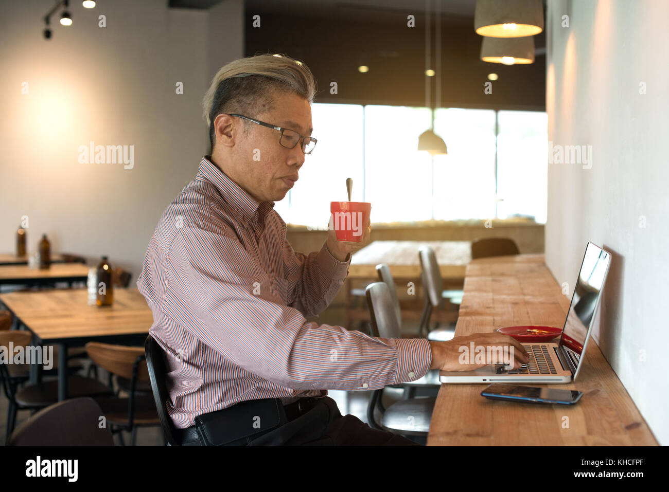 asian senior man using laptop Stock Photo - Alamy