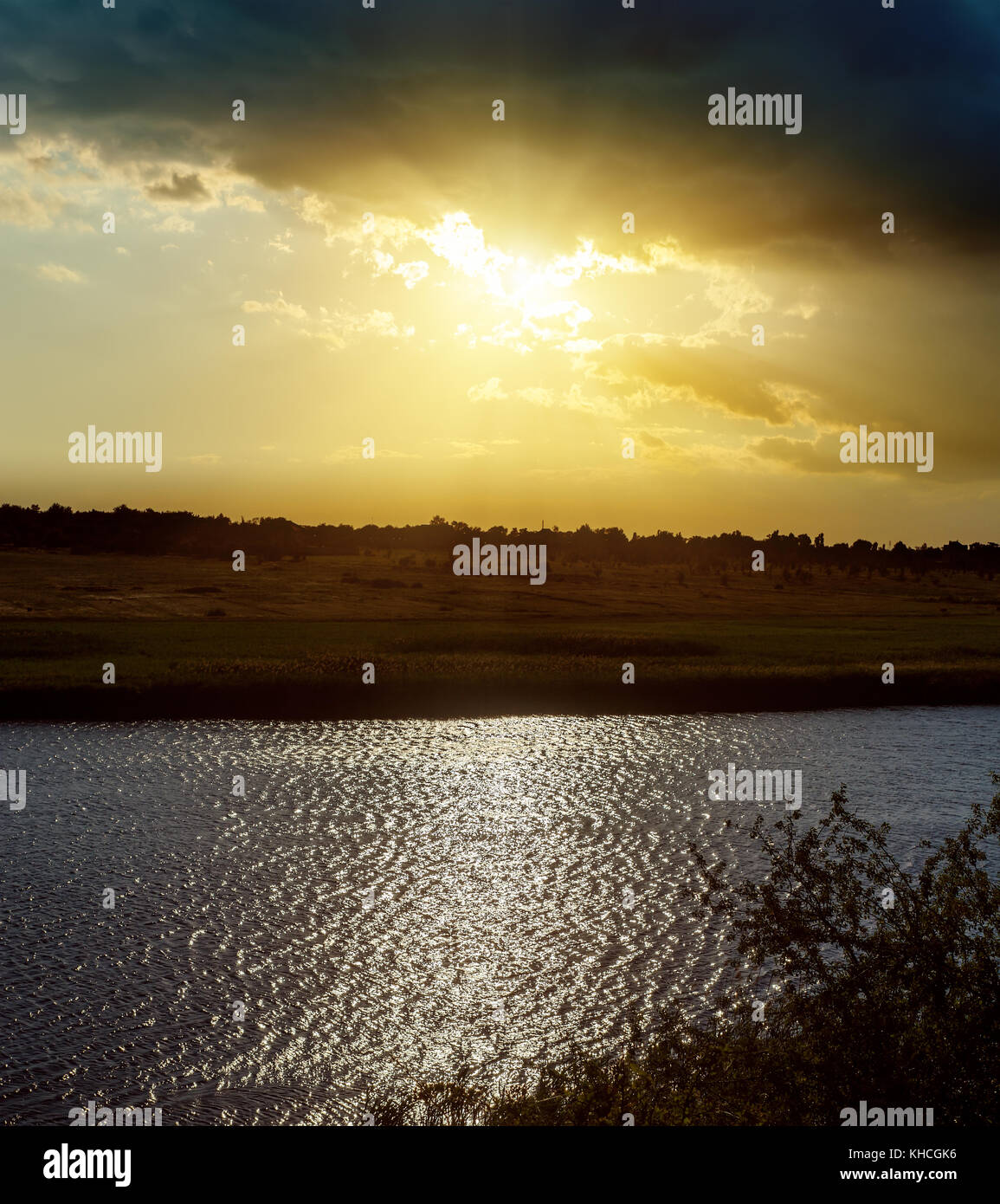 dramatic sunset and river with reflections Stock Photo - Alamy