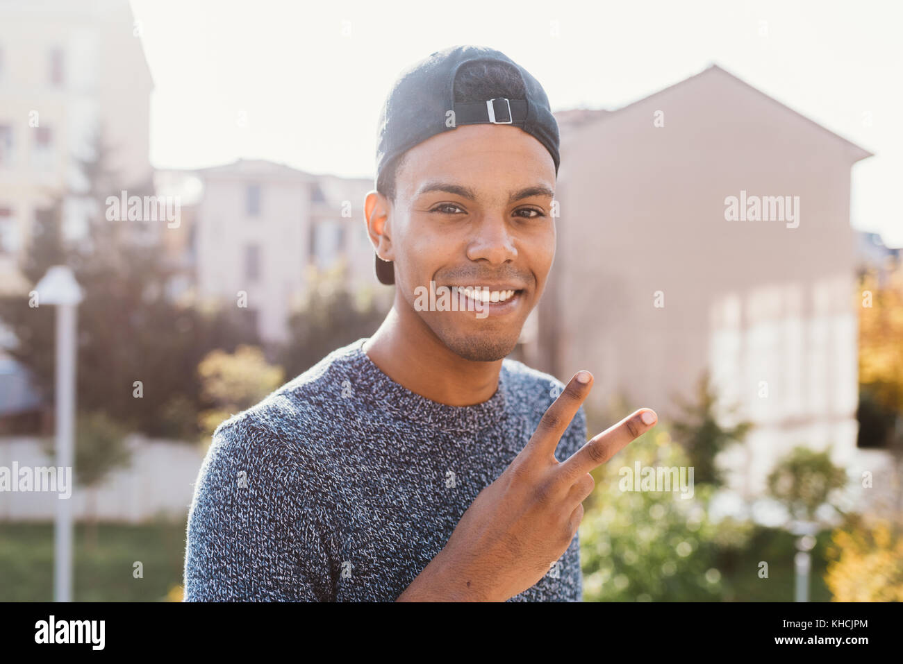 Portrait young black man looking camera smiling - getting away from it ...