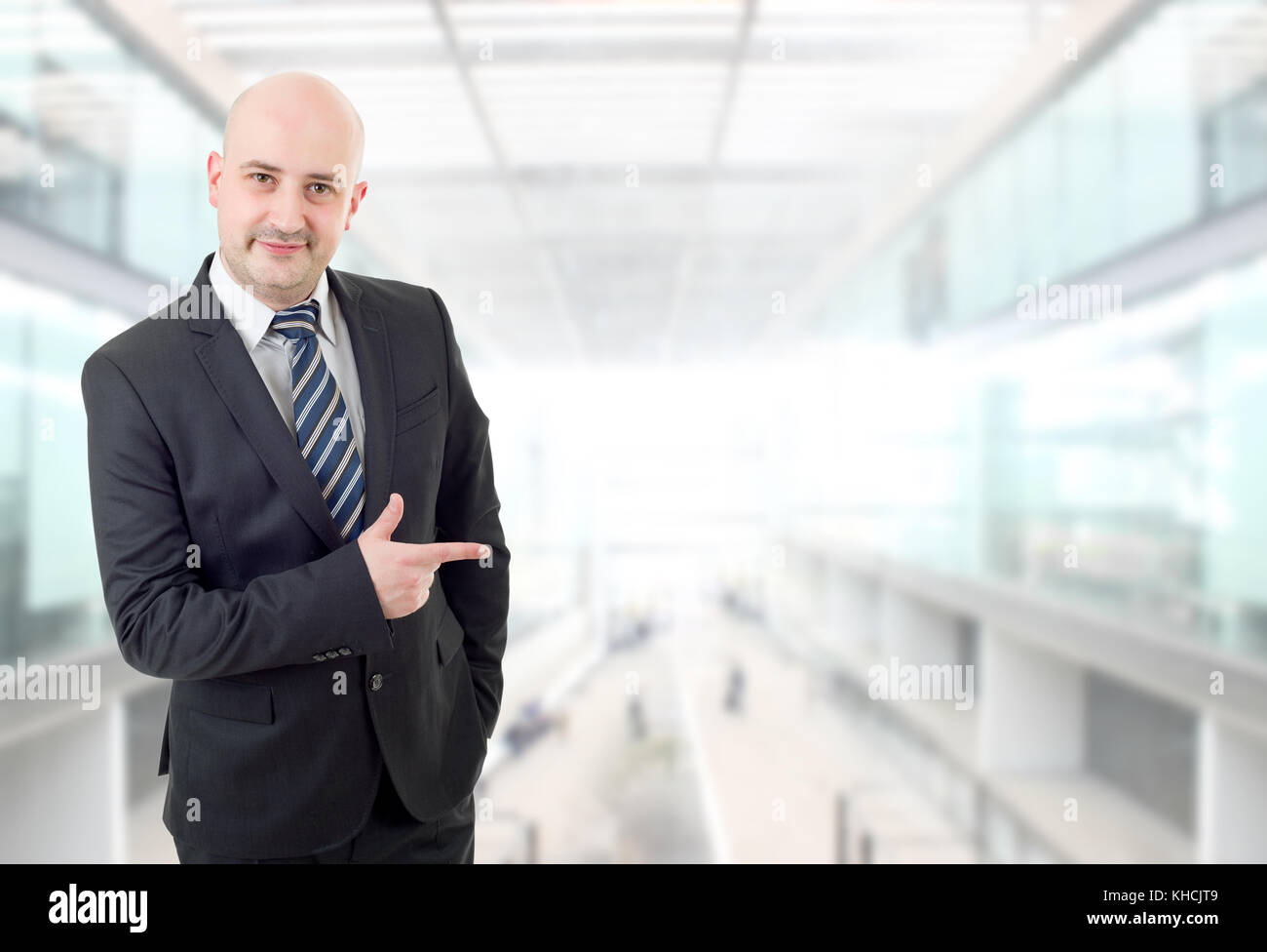 happy business man pointing, at the office Stock Photo - Alamy