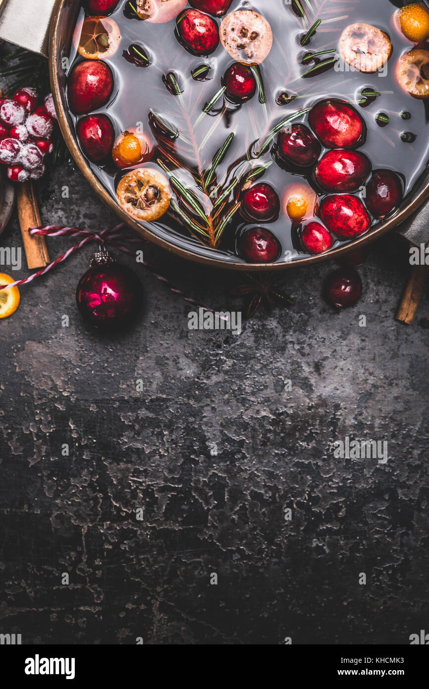 Mulled wine or punch in cooking pot on dark vintage background, top ...