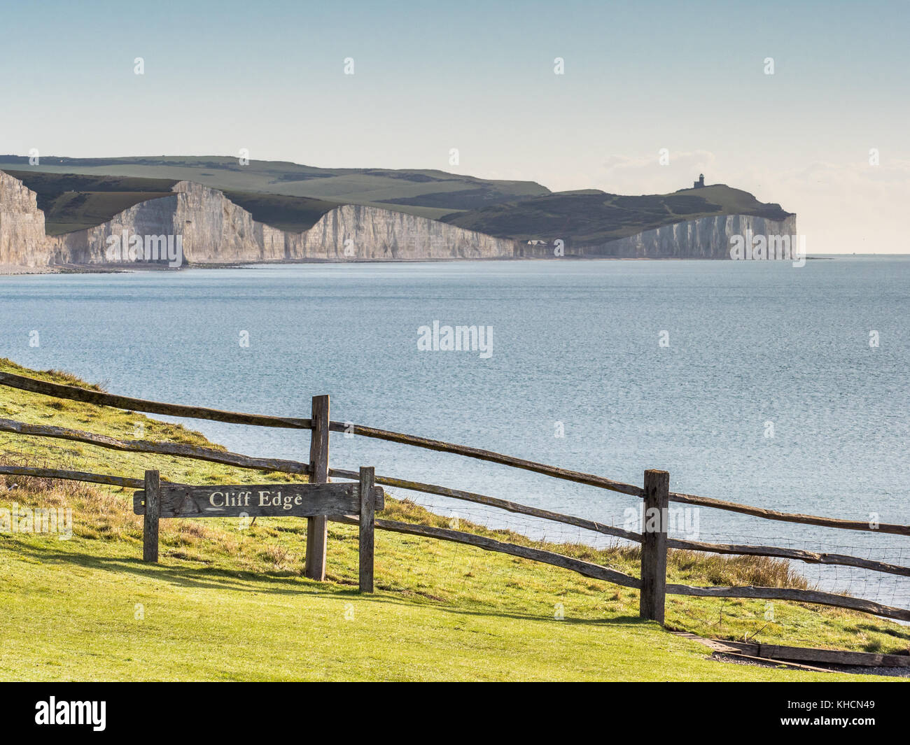 A sign marked 'Cliff edge' is seen at the top of a cliff near the Seven ...