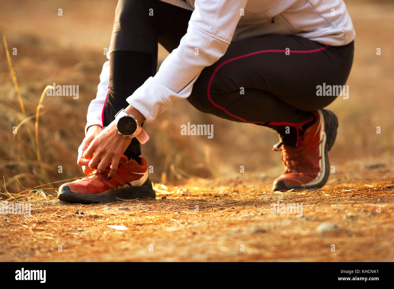Horizontal photo of a girl runner getting ready before a run in the ...