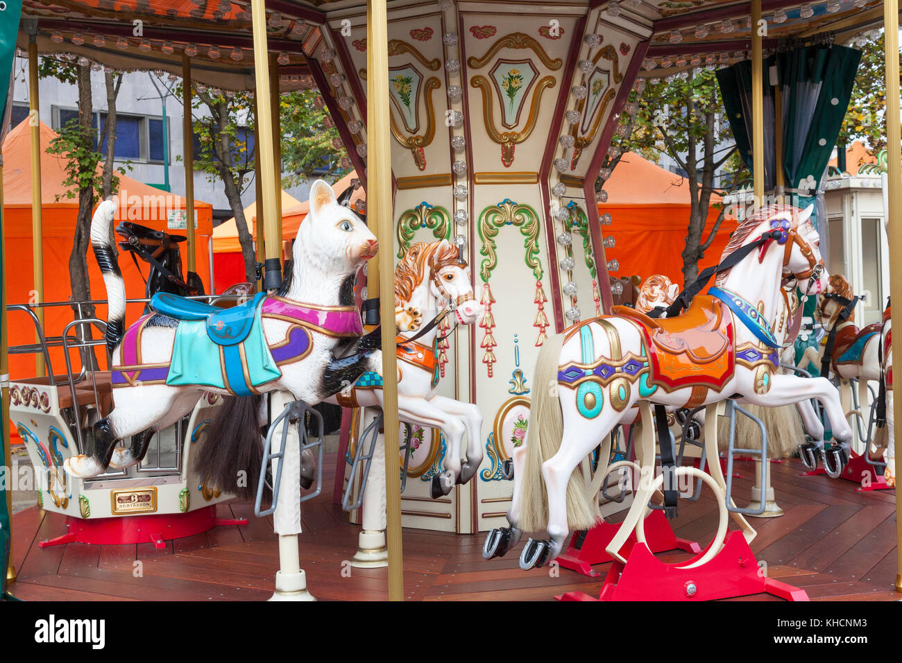 Colourful animal rides on a small Italian Bertazzon carousel with a ...