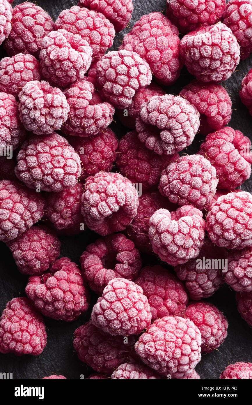 Frozen raspberry on black slate. Close up. Top view. High resolution ...