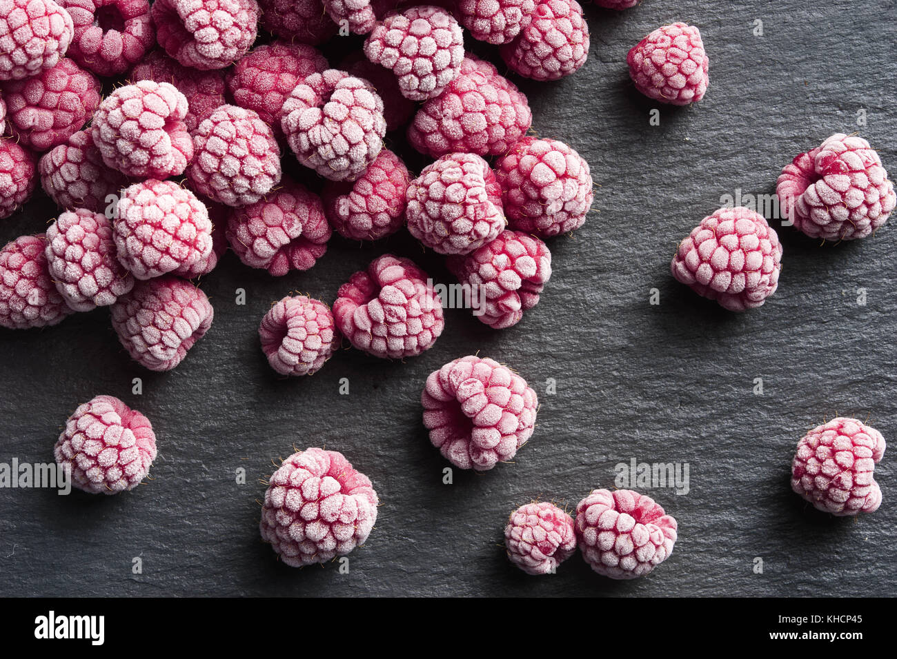 Frozen raspberry on black slate. Close up. Top view. High resolution ...