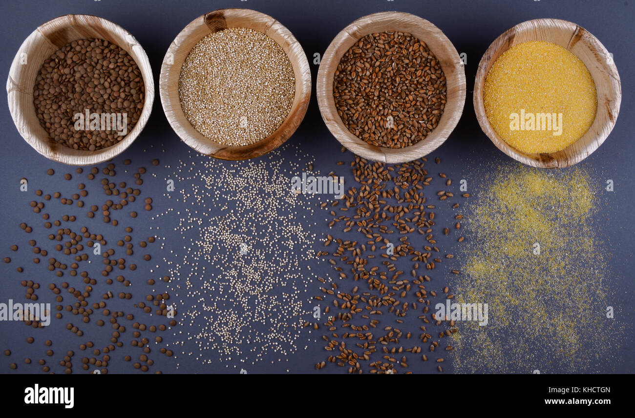Four sorts of cereals in bowls on the dark background. Wheat grain ...