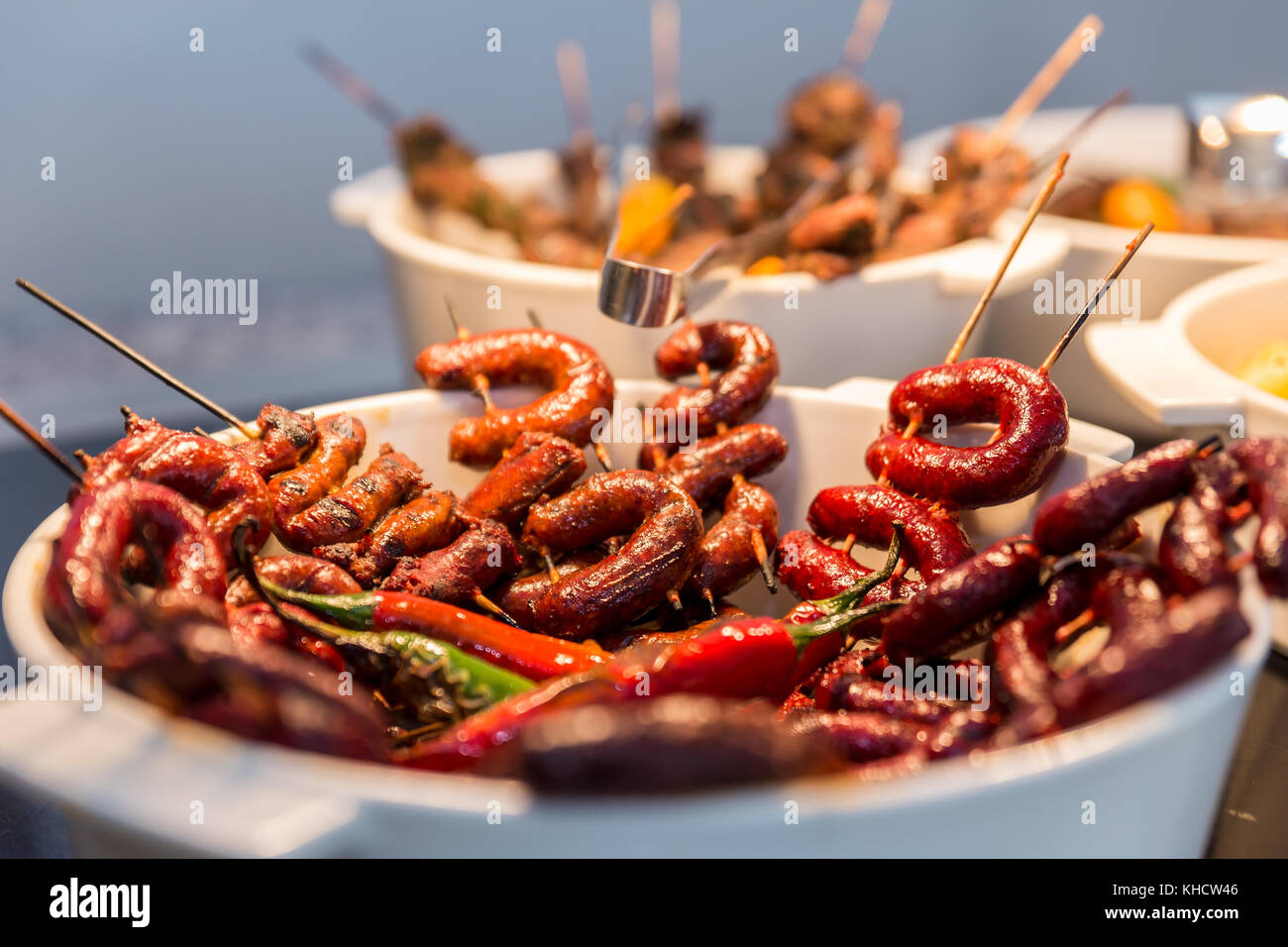 Red sausages in skewers ready for barbecue on a hotel 5 stars buffet ...