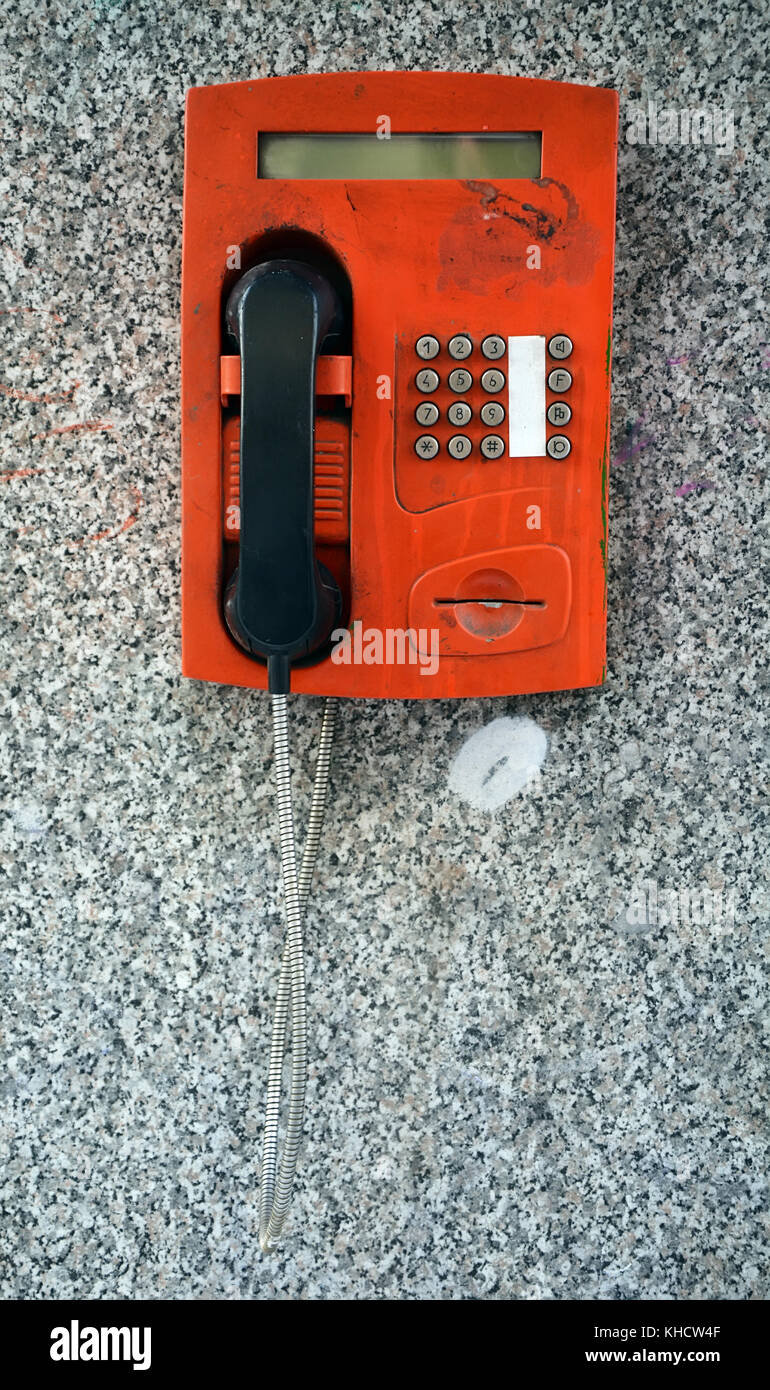 Old red telephone booth on the grey background Stock Photo - Alamy