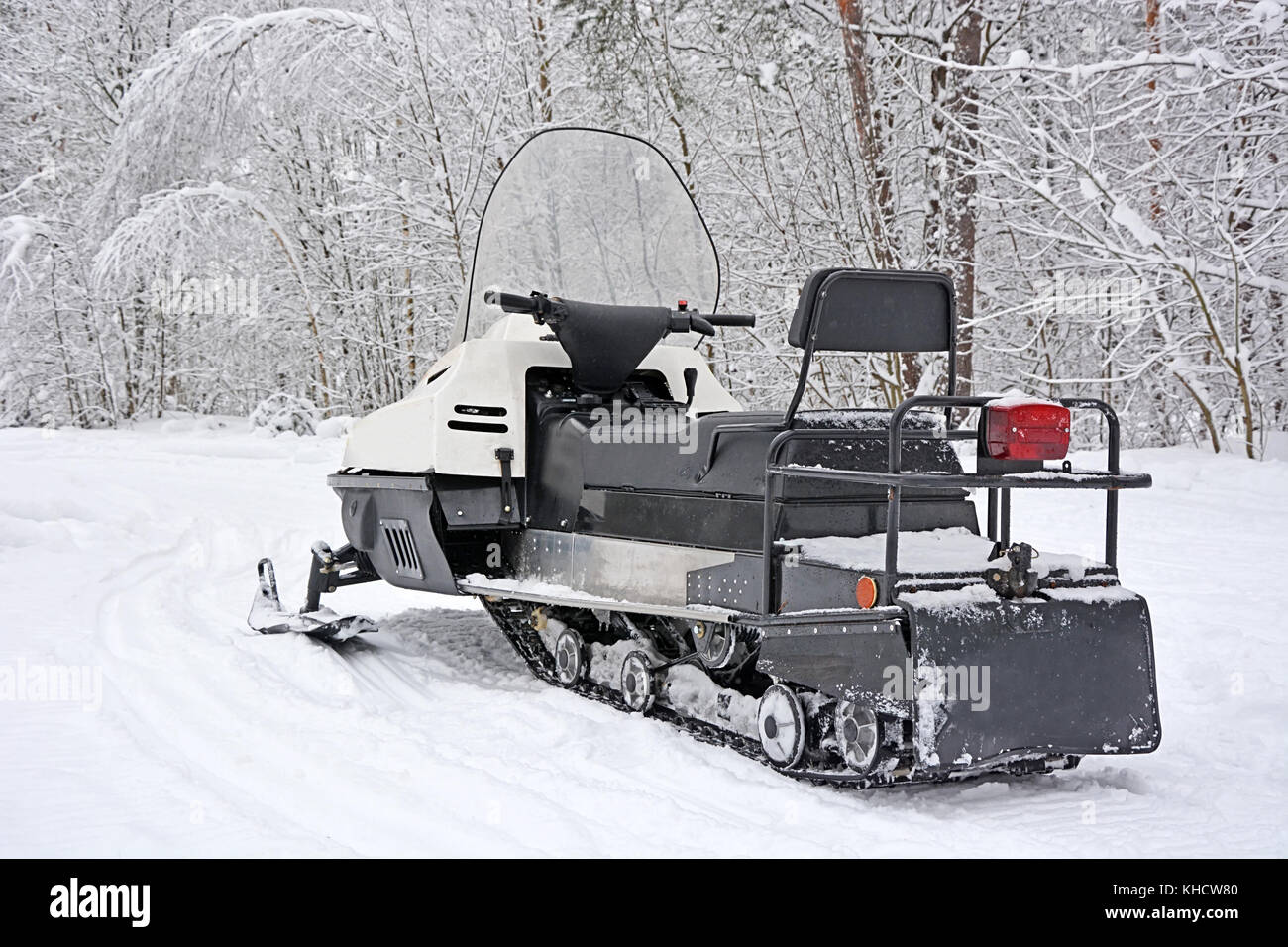 Snowmobile at the winter forest. Snowy road Stock Photo - Alamy