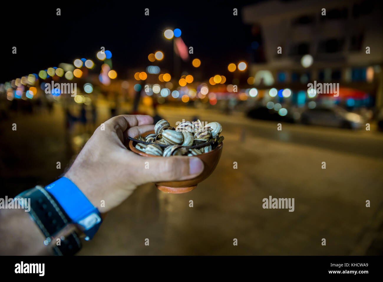 Man holding cooked snails in Morocco at night Stock Photo - Alamy