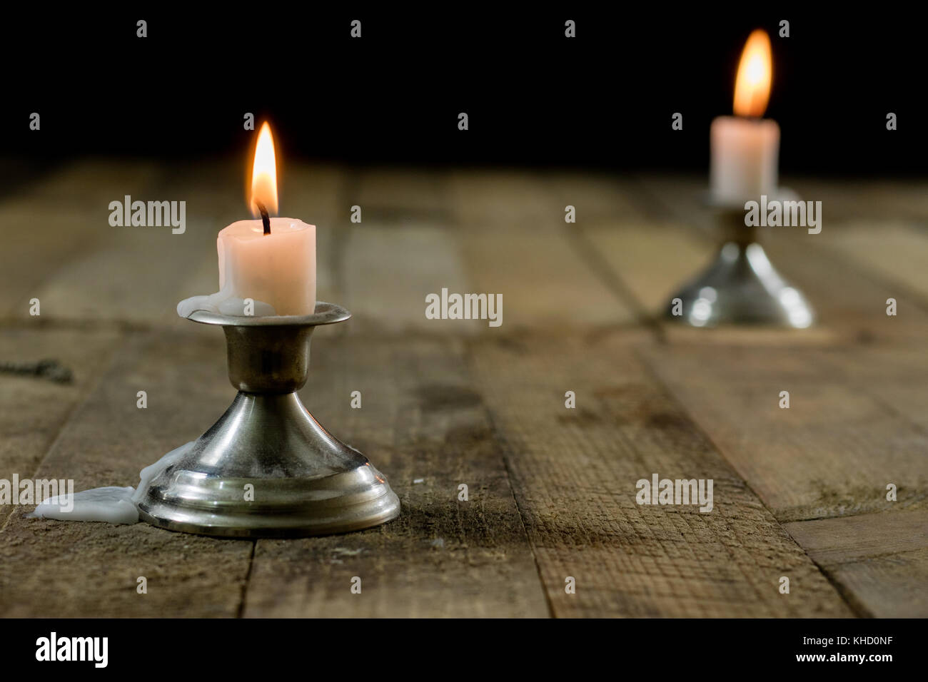 Burning candles in vintage candlesticks hi-res stock photography and ...