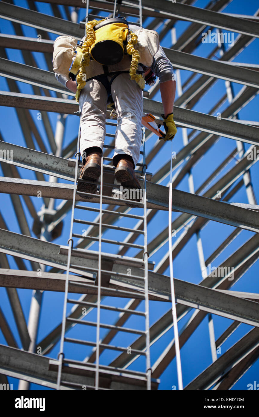 Climber ascending cell phone tower. Seen in USA Stock Photo - Alamy