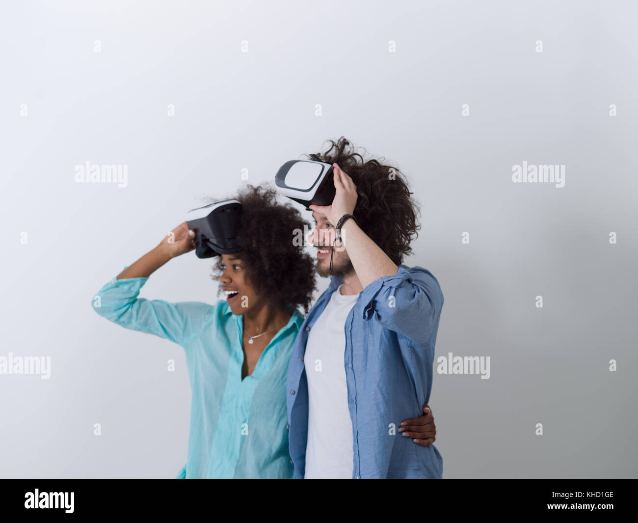 Happy multiethnic couple getting experience using VR headset glasses of ...
