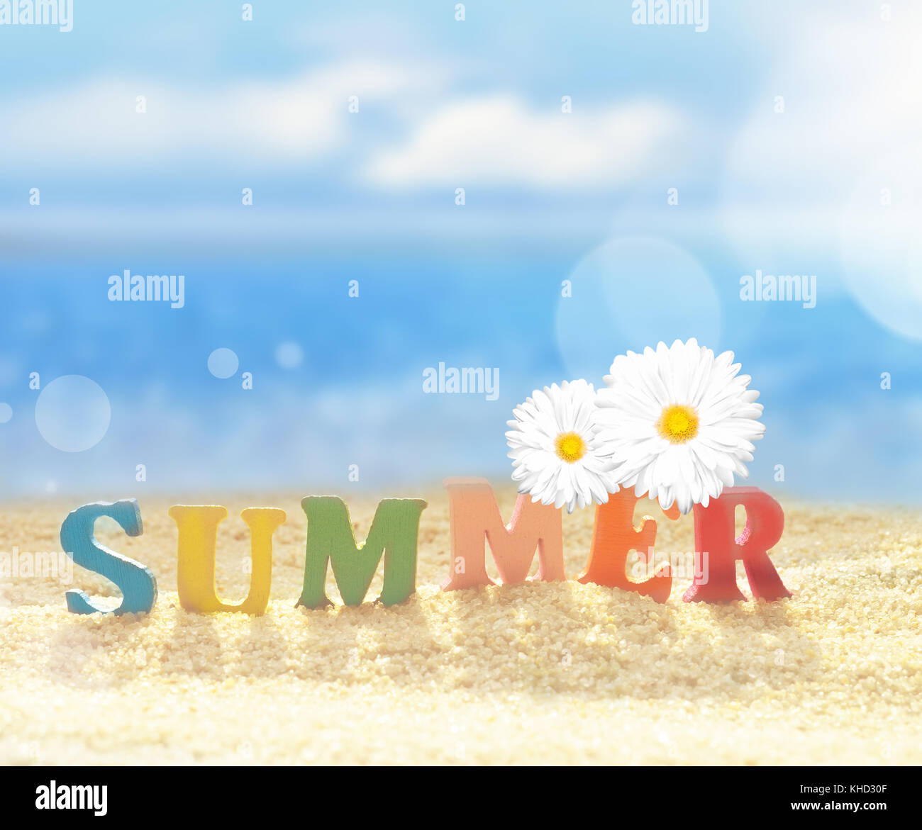 Summer beach. Letters and flower on a beach sand against the background ...