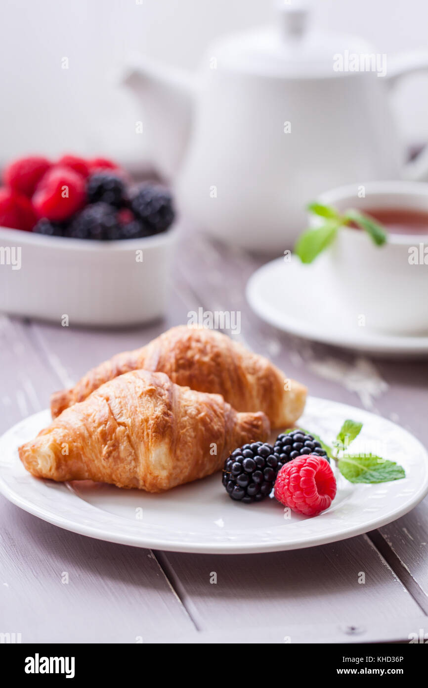 European breakfast with fresh berries on the wooden background. Toned ...