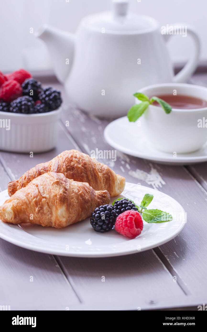 European breakfast with fresh berries on the wooden background. Toned ...