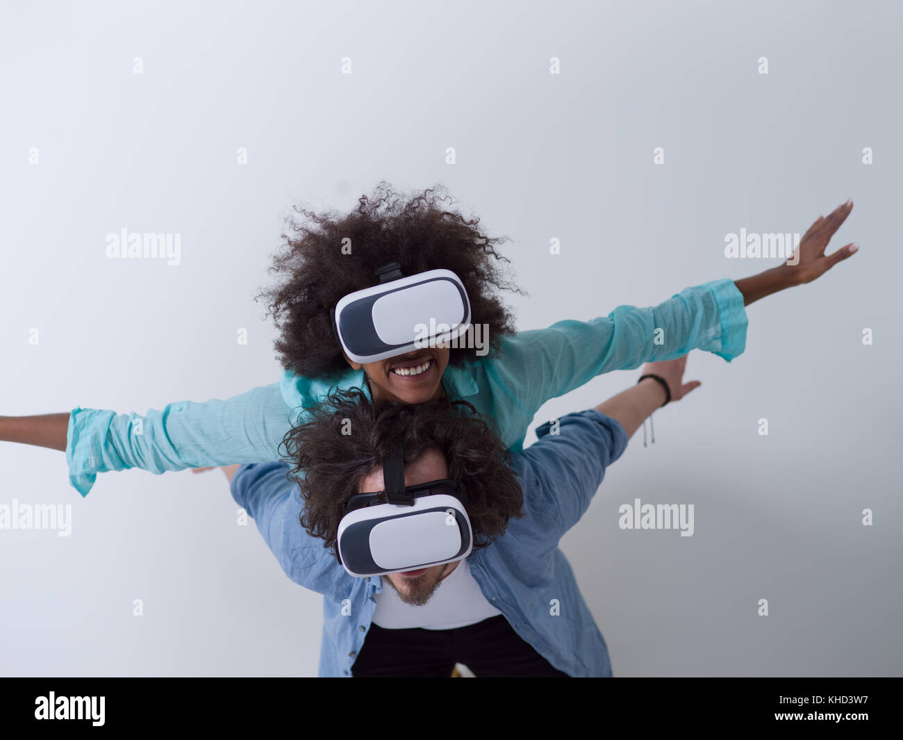 Happy multiethnic couple getting experience using VR headset glasses of ...