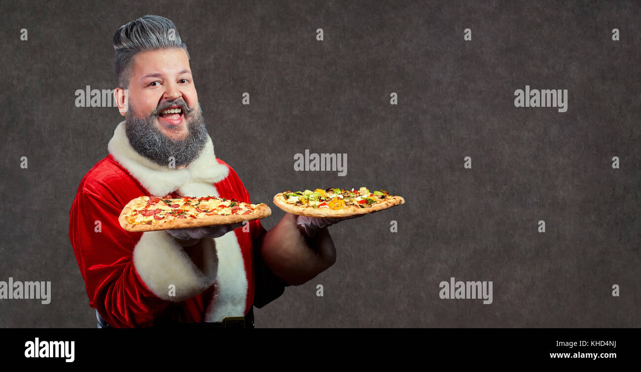 Santa Claus with pizza in hands Stock Photo - Alamy