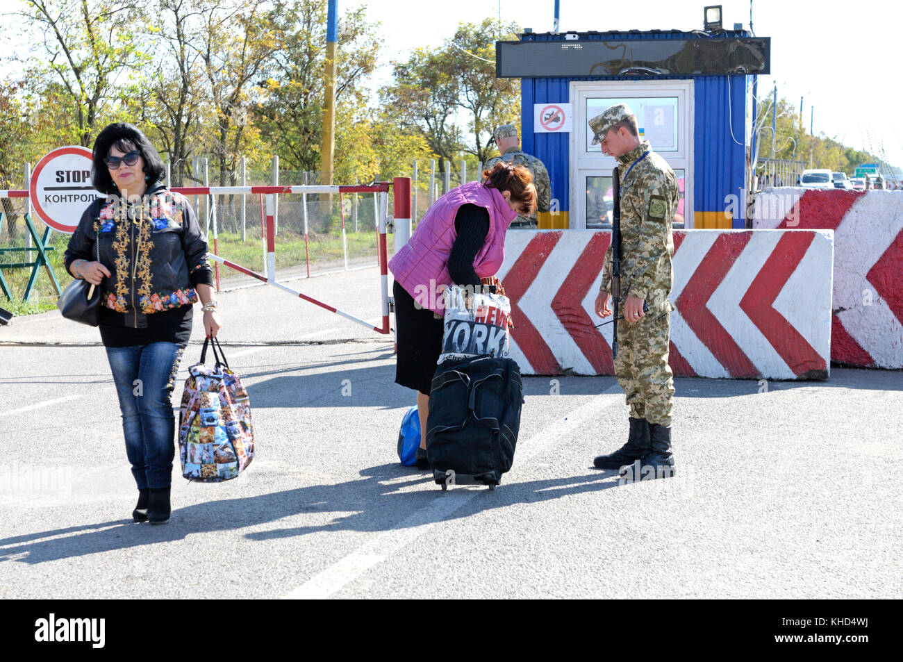 Border guard checking bags of travelers at the border crossing point ...